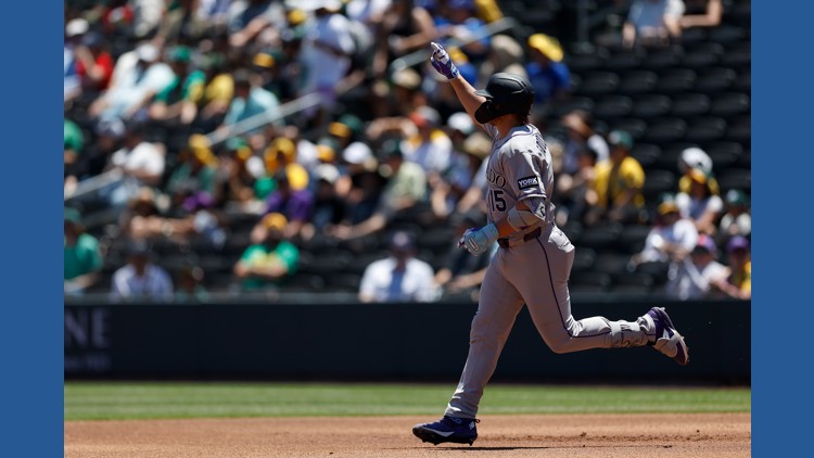 Rockies set club record for runs in victory over A's in Las Vegas heat