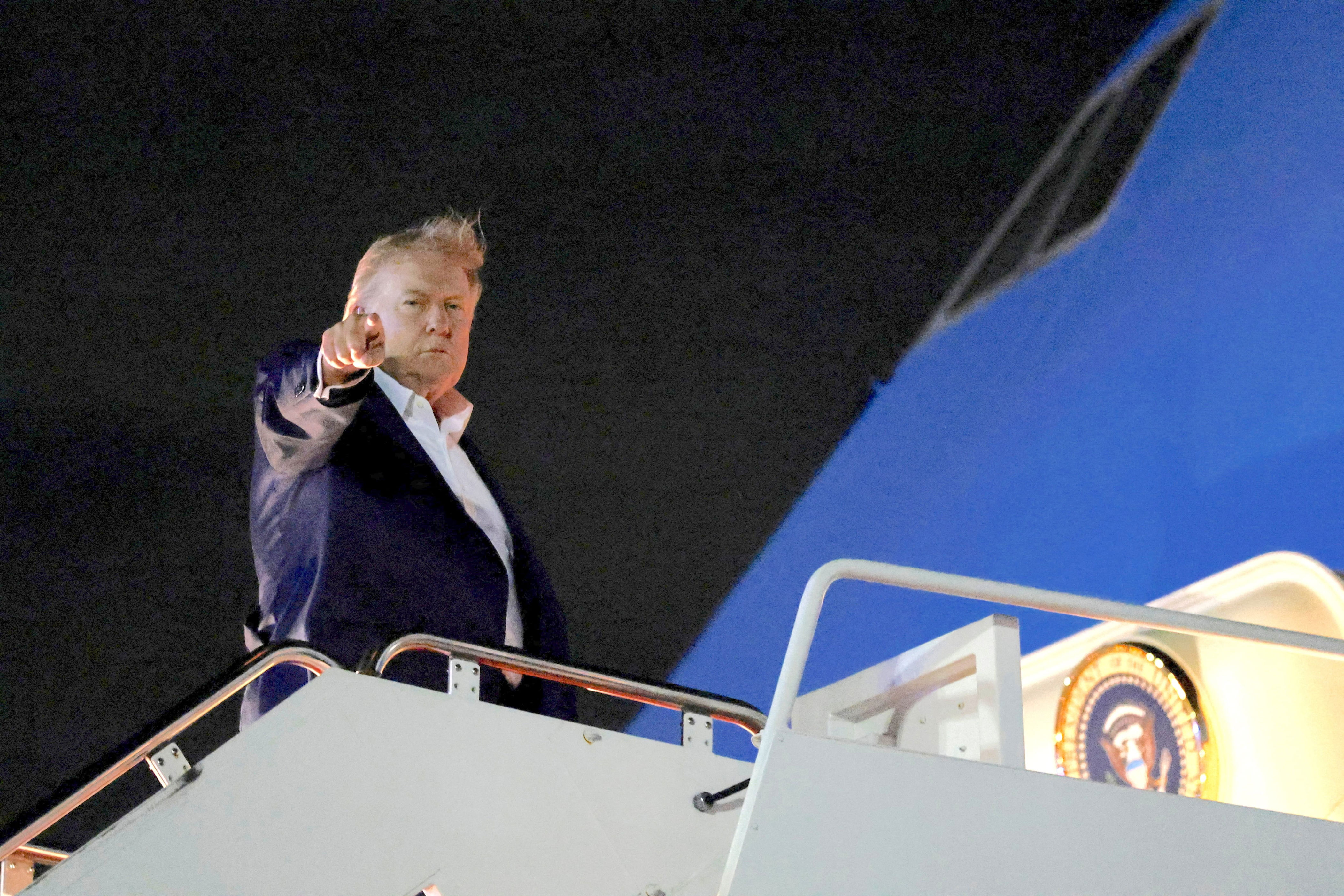 Trump posts through night on flight to G7 summit