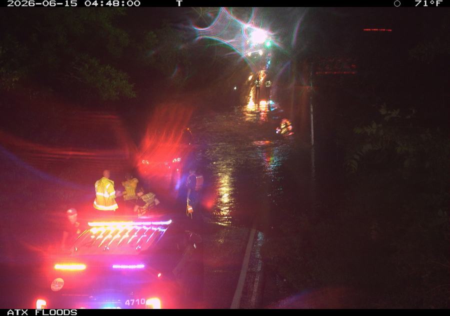 Driver rescued after going around barricade, trying to cross flooded ...