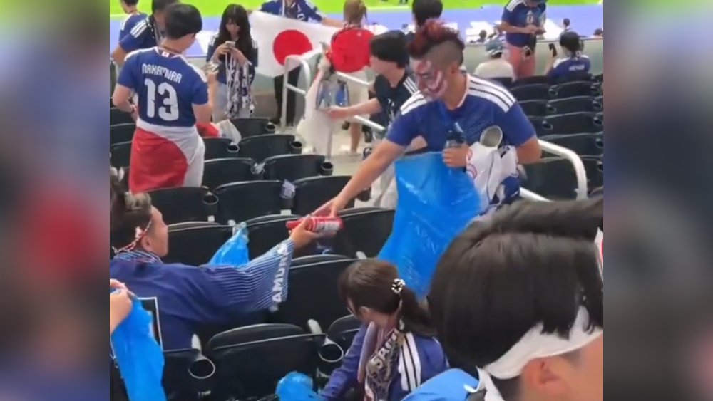 Japanese fans clean up the stands after a World Cup match