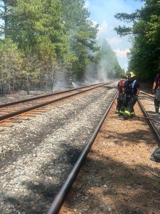 Fire crews battle spot fires along railroad tracks near Kenyon Road