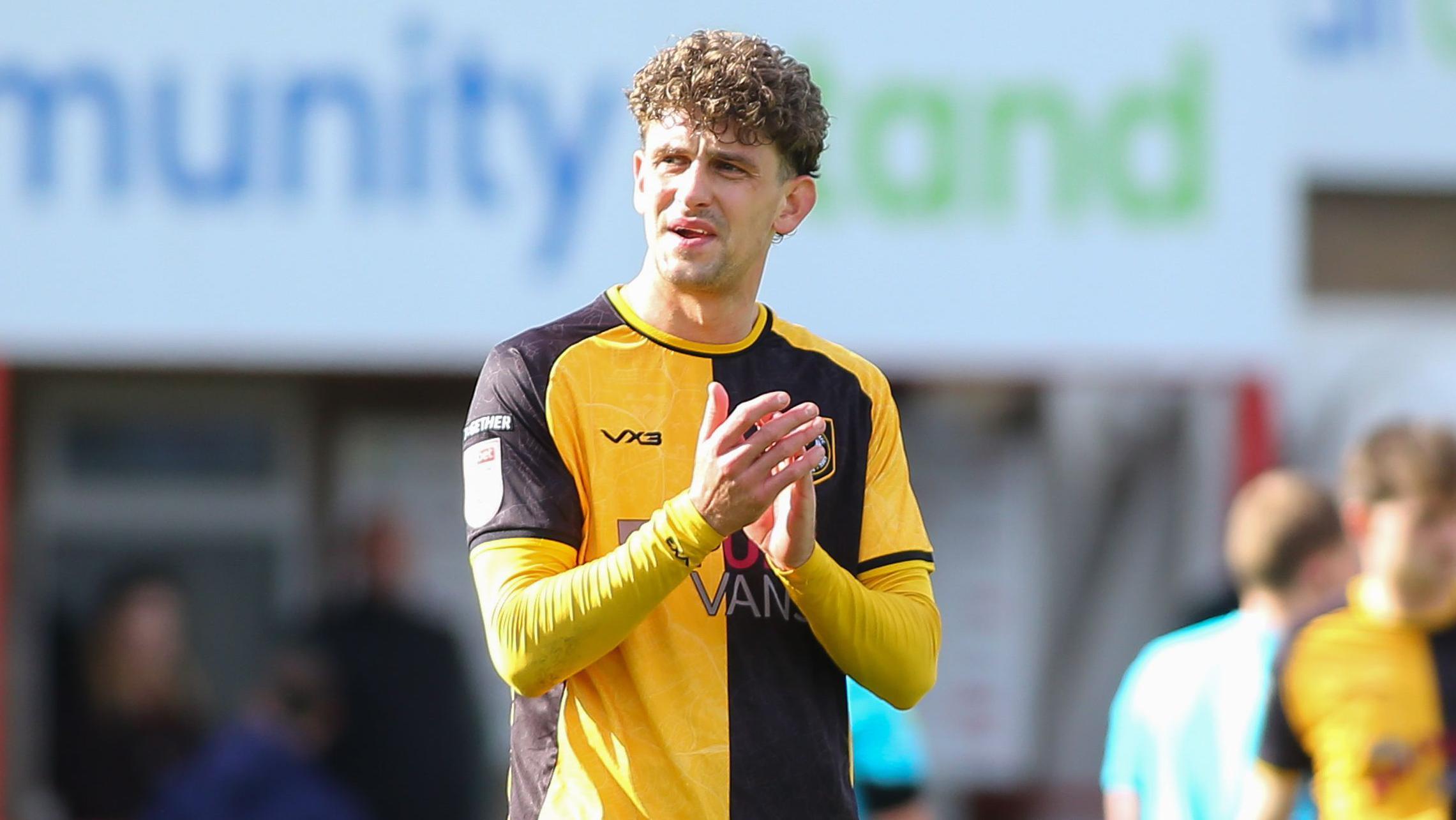 Biggins signs permanent deal with Newport