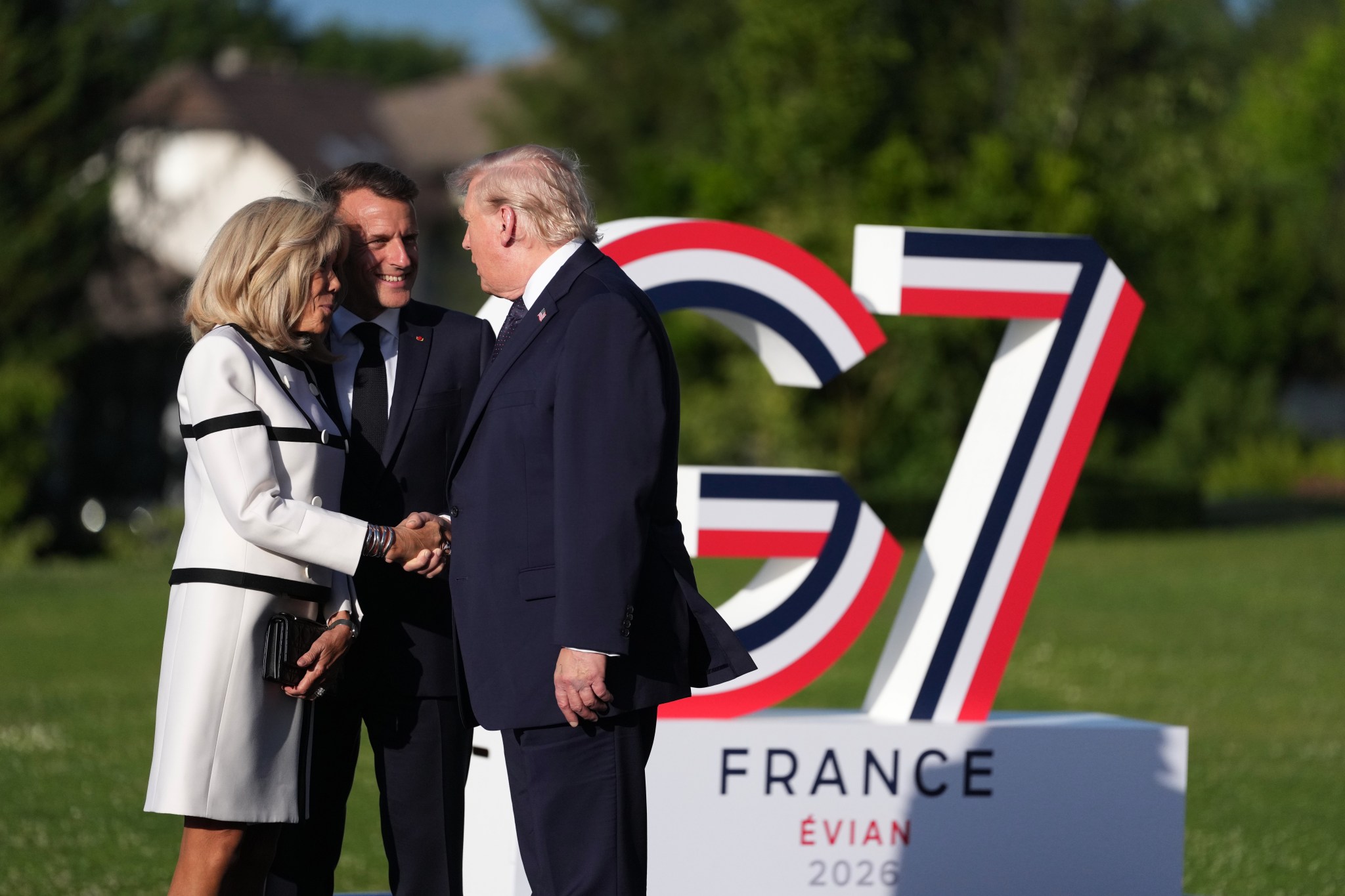Trump holds tight to Brigitte Macron at G7 despite his recent barbs