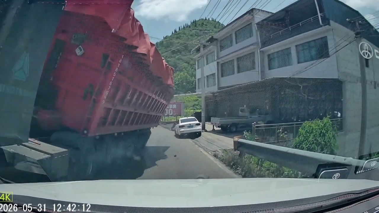 Truck teeters but stays upright on narrow mountain road