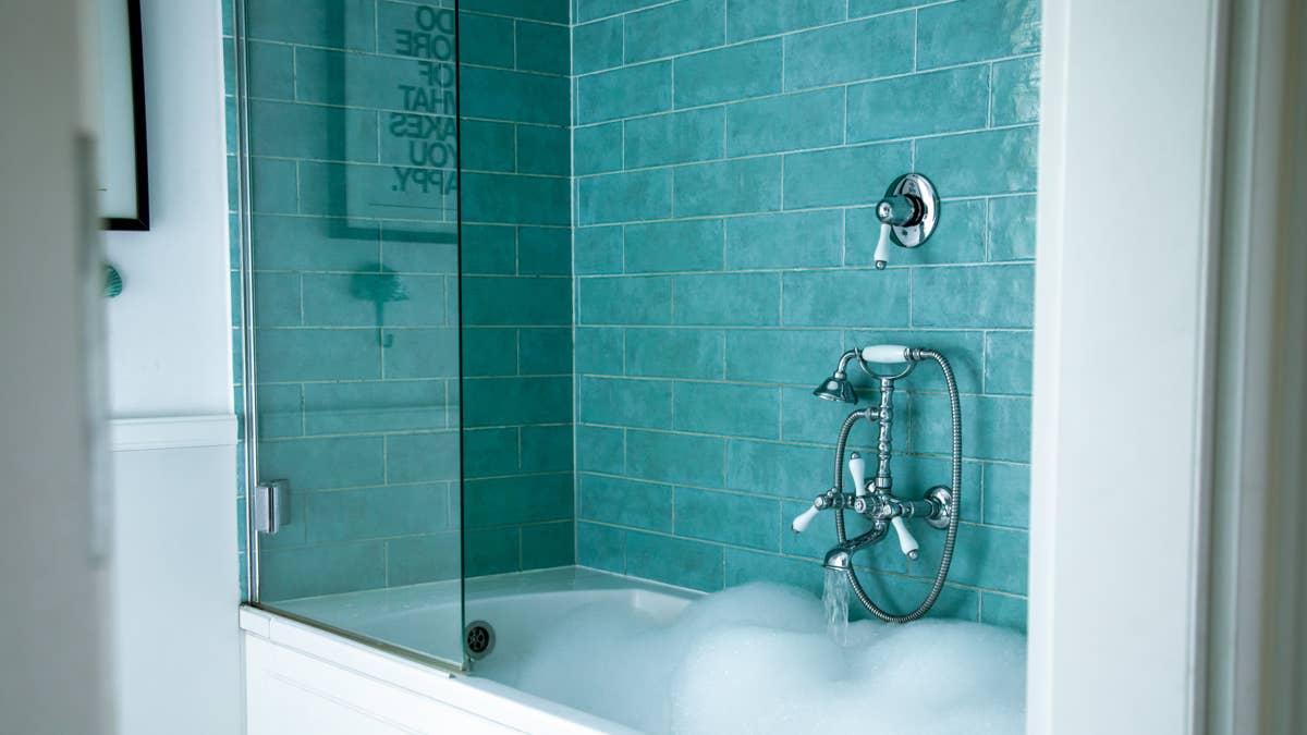 Couple unearths original 1950s teal shower from 'landlord special ...