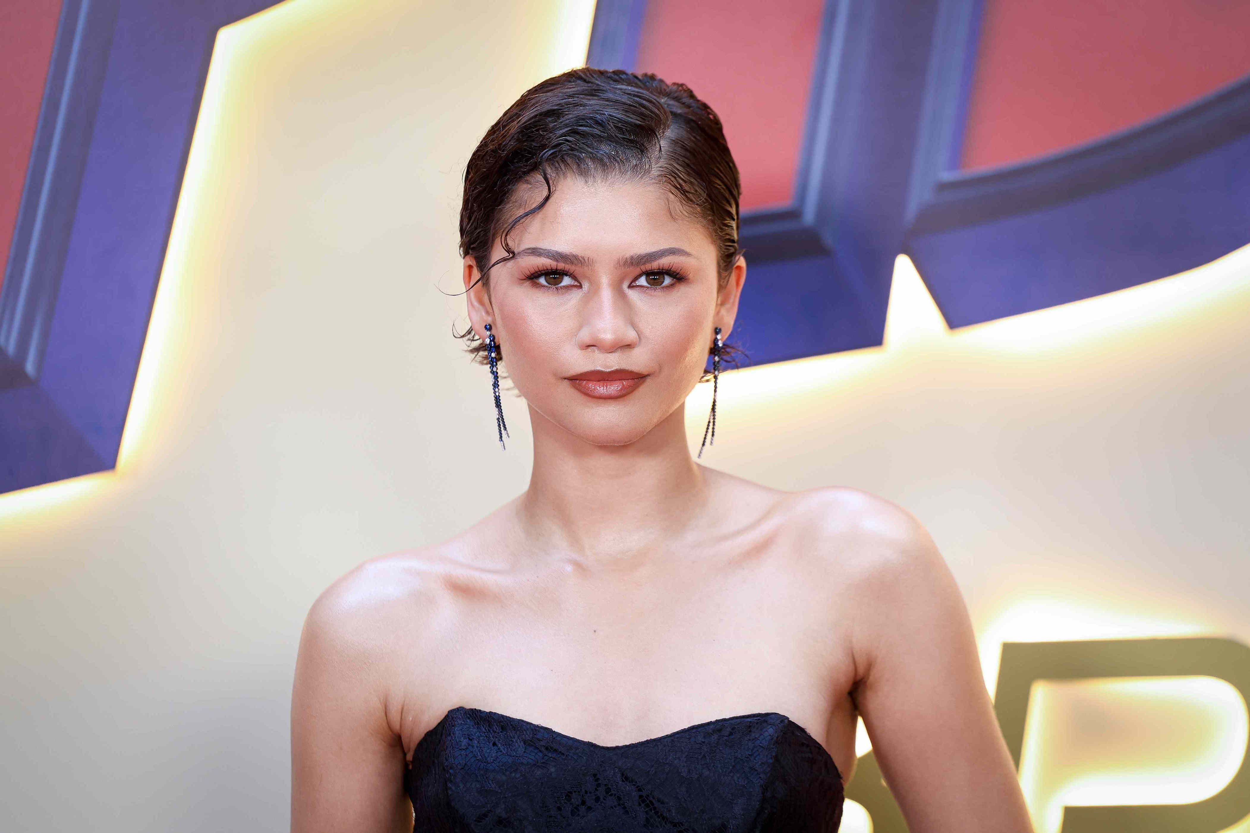 Zendaya wows in a bright red hip-baring look that features whimsical ...