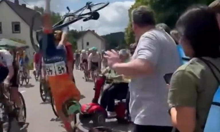 Elderly fan in a mobility scooter causes huge cycling race crash