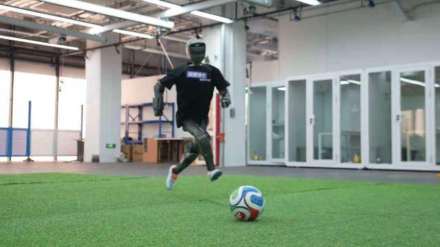 Tiny RoboCup star T1 kicks a soccer ball hard enough to smash a hole in ...