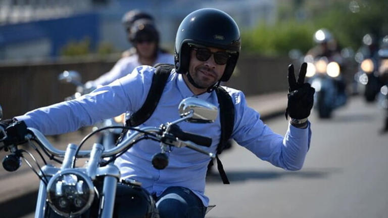 What does it mean when a biker points two fingers up?