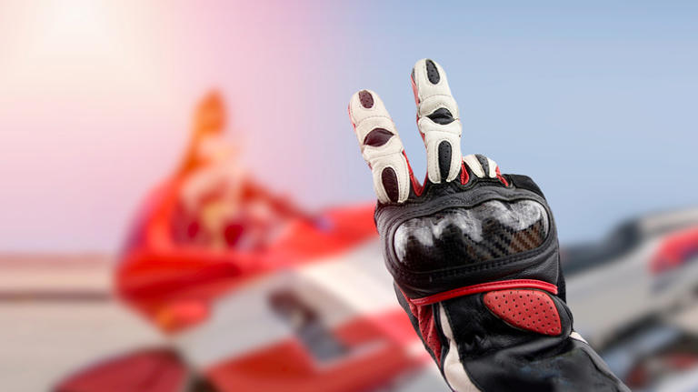 What does it mean when a biker points two fingers up?