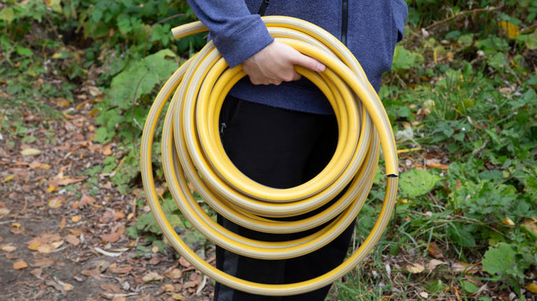 Don't toss an old garden hose, turn it into adorable porch decor