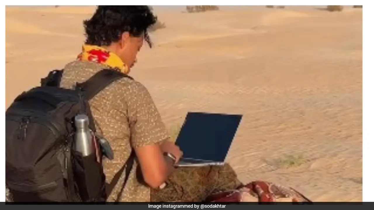 Man seen working on laptop while riding camel in Sahara Desert leaves ...