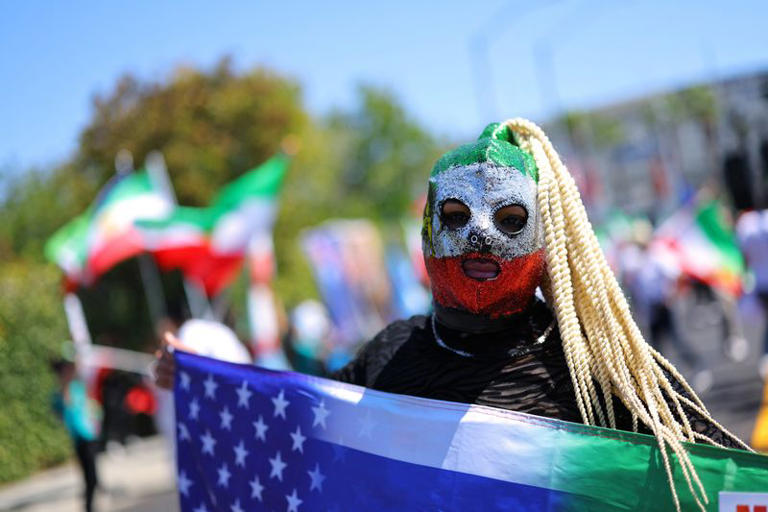 Iranian Americans wave protest flags as Iran play World Cup opener