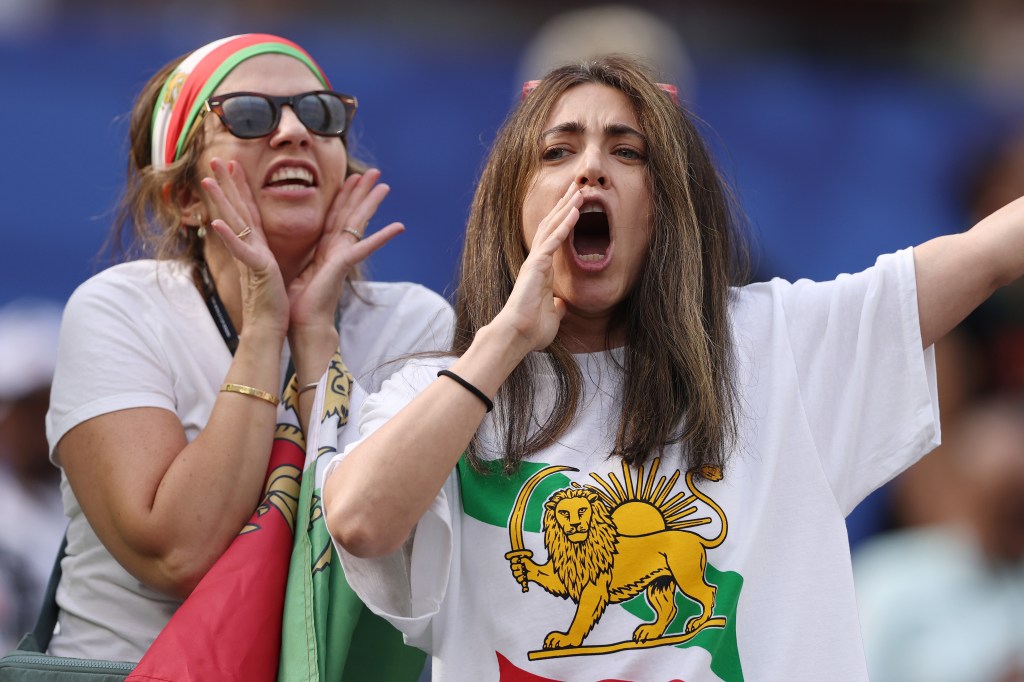 Iranian World Cup soccer fans wave pre-revolutionary flag inside ...