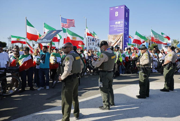 Iranian Americans wave protest flags as Iran play World Cup opener