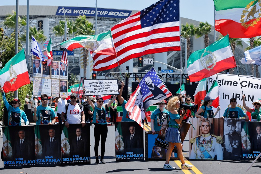 Iranian World Cup soccer fans wave pre-revolutionary flag inside ...