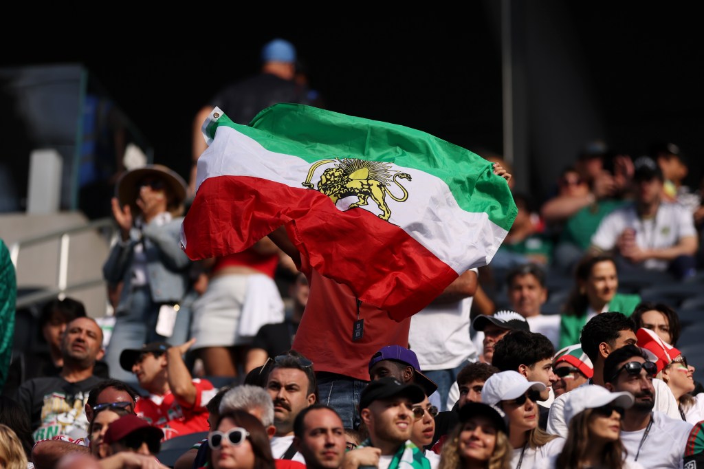 Iranian World Cup soccer fans wave pre-revolutionary flag inside ...