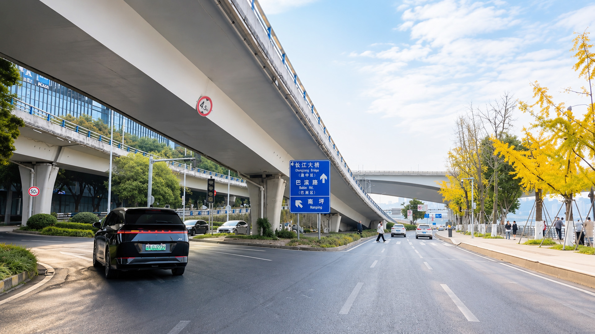 Driving along China’s riverside road under layered highways