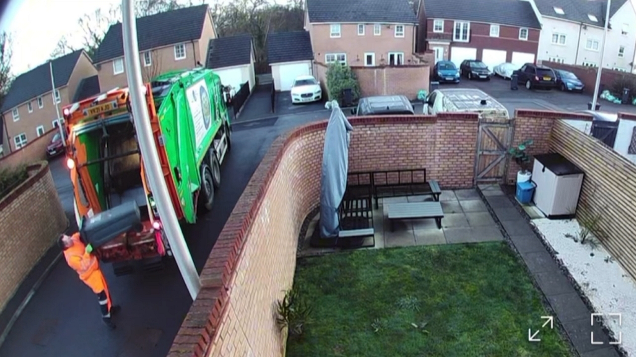 Trash collector tosses bin into truck in Cardiff!