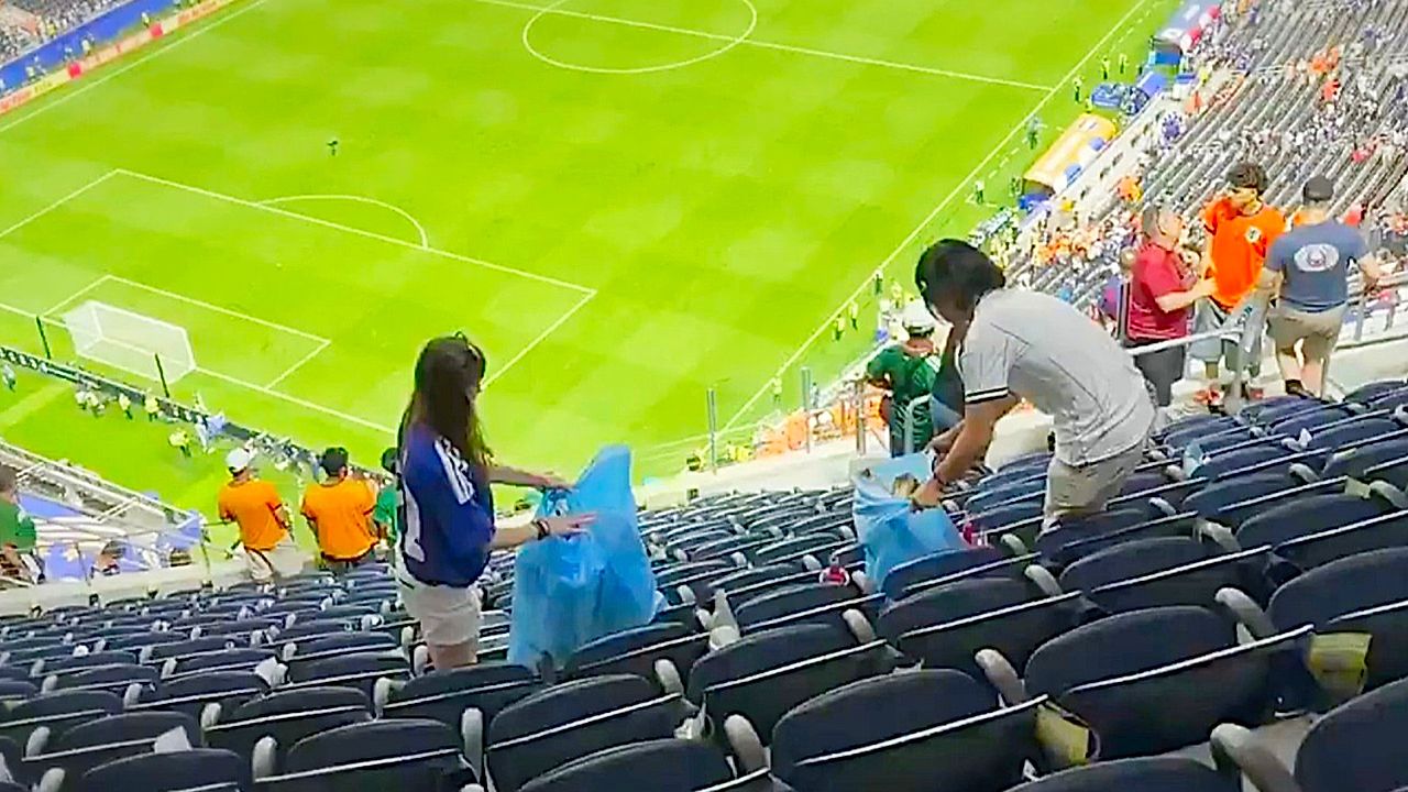Japan fans stay behind to clean stadium after World Cup draw with ...