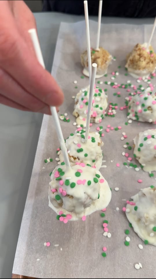Soft cake pops dipped in white chocolate and sprinkles