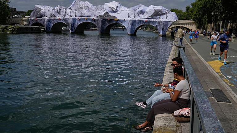 Crowds flock to JR's giant cave installation on Paris' Pont Neuf