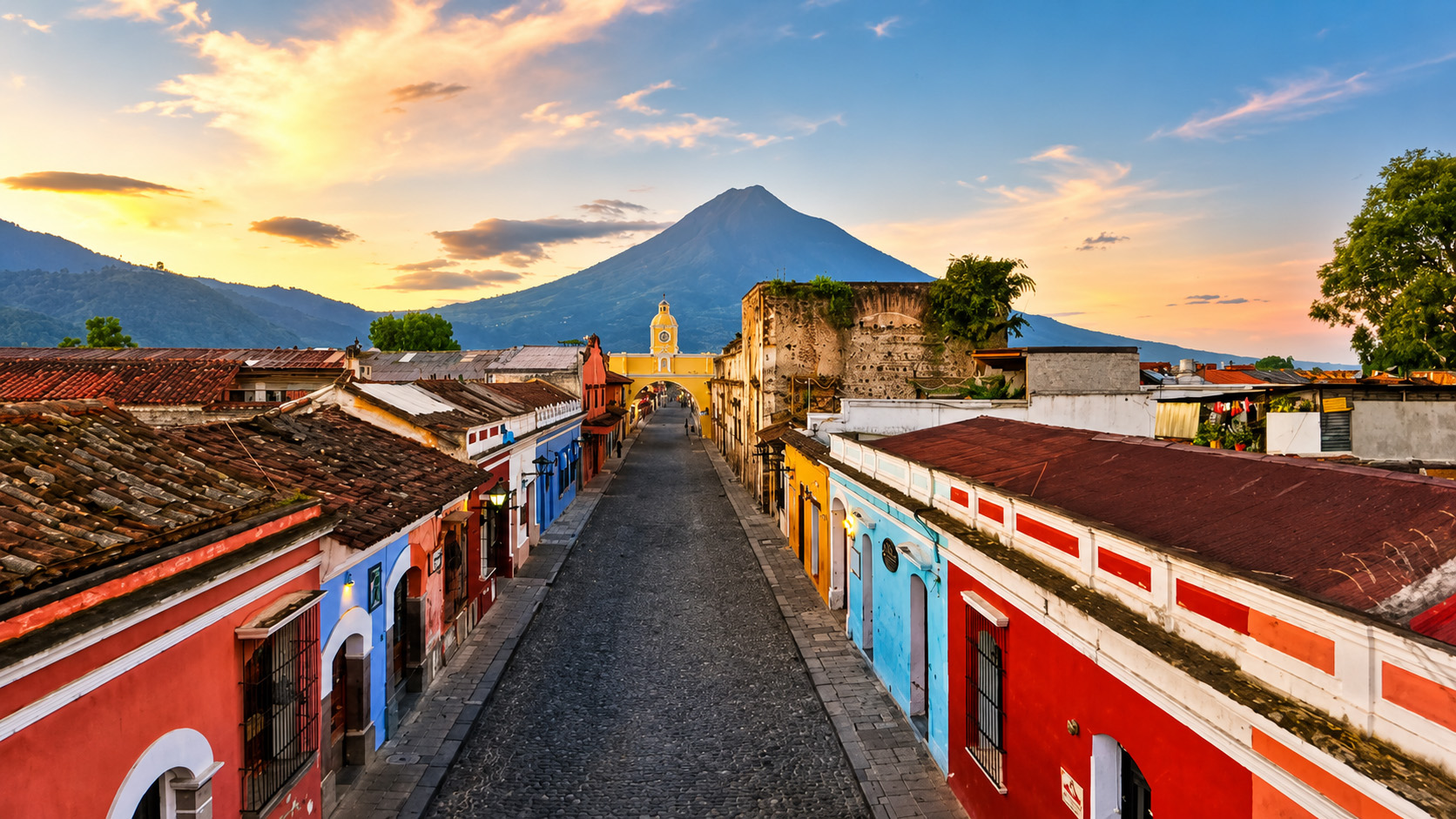 Antigua Guatemala’s colorful colonial streets beneath a volcano