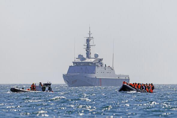 French Navy hand life jackets to small boat migrants trying to reach ...
