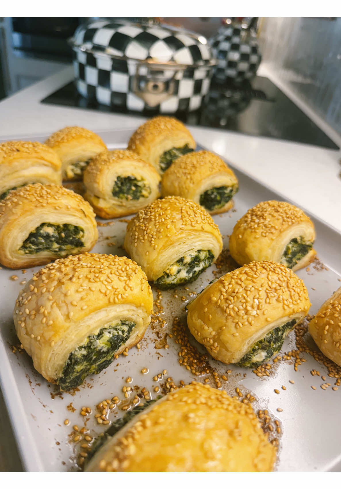 Homemade golden spinach and feta puffed pastry rolls finished with ...