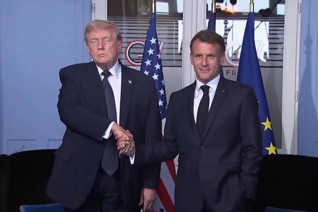Trump 'struggles to speak' during Macron meeting as he 'hides bruised hand'