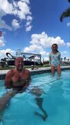 Pool day turns hilarious as little girl nails bottle flip on grandpa's head