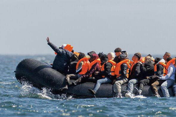 French Navy hand life jackets to small boat migrants trying to reach ...