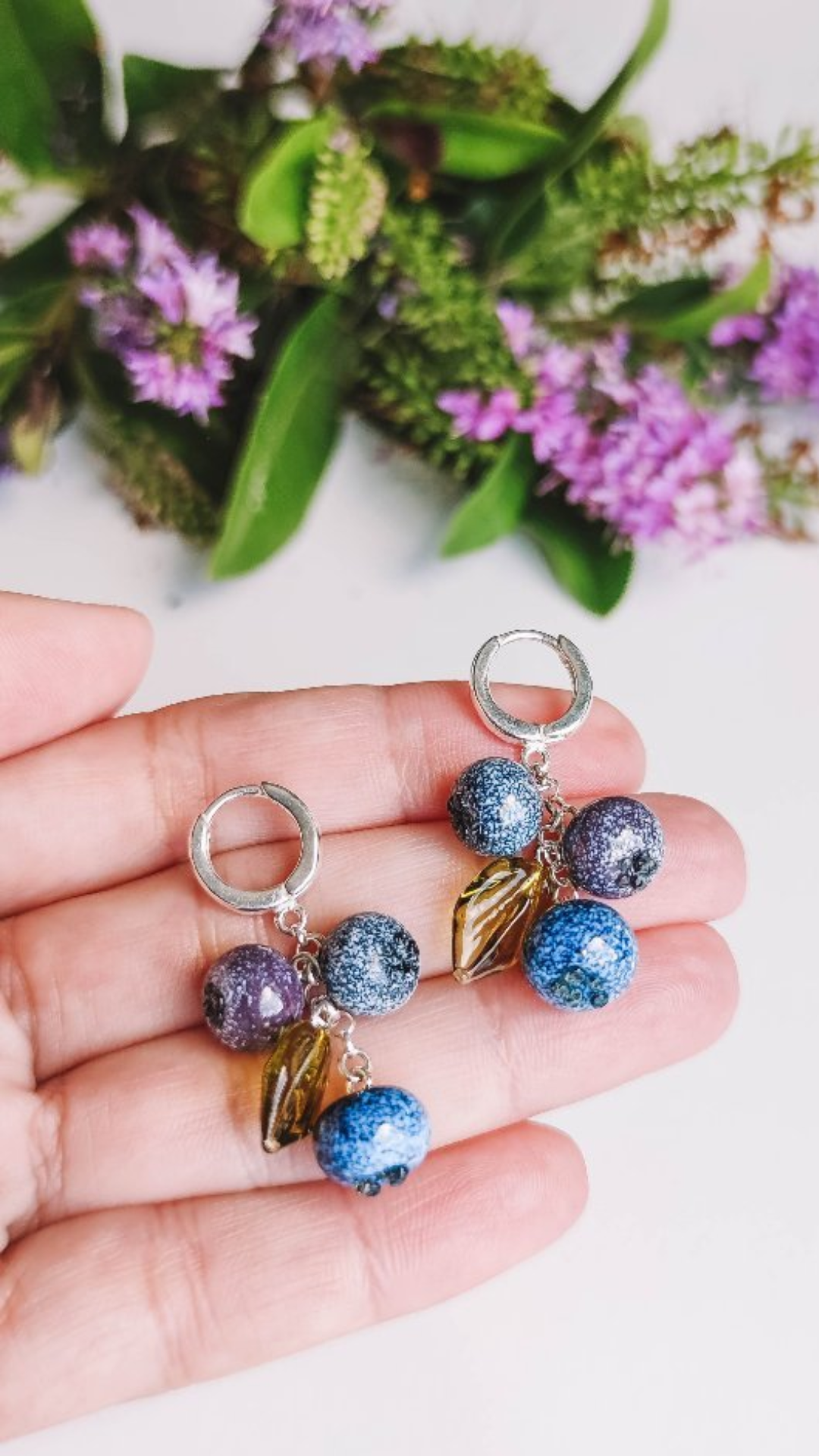 Tiny blueberry glass bead craft so realistic it looks edible
