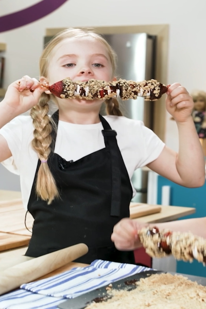 Making chocolate strawberry skewers