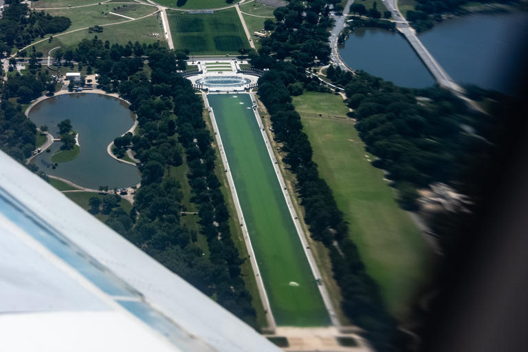 Workers bleach reflecting pool after it turns green
