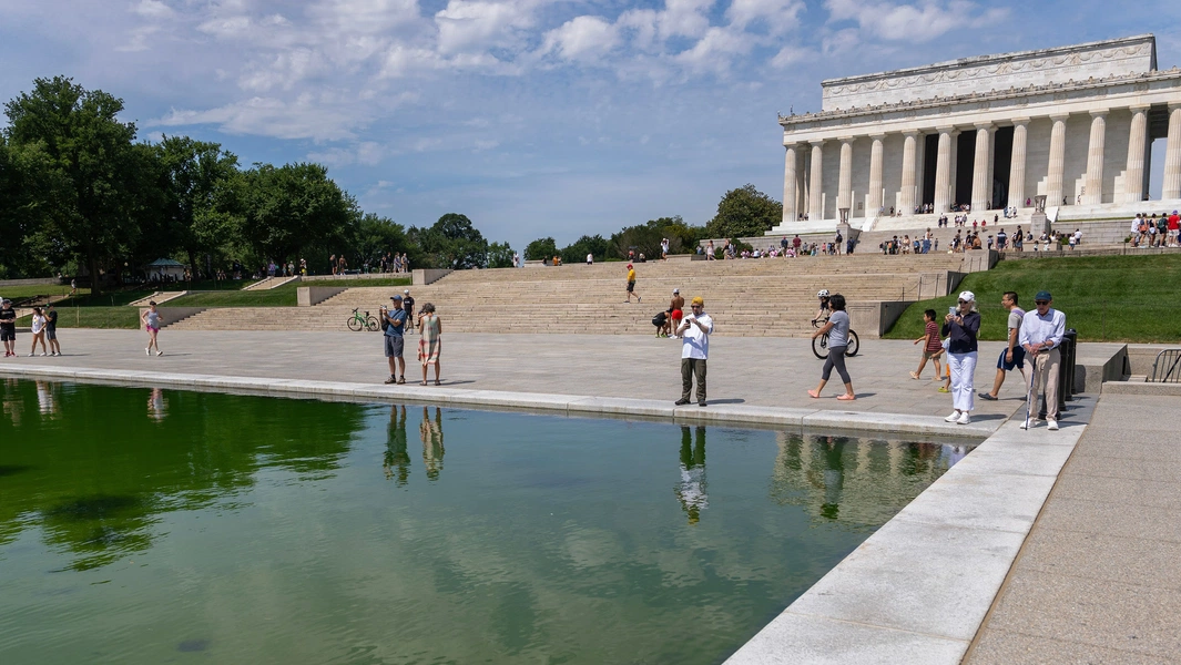 Workers pour peroxide into algae-filled pool after $14.2m revamp