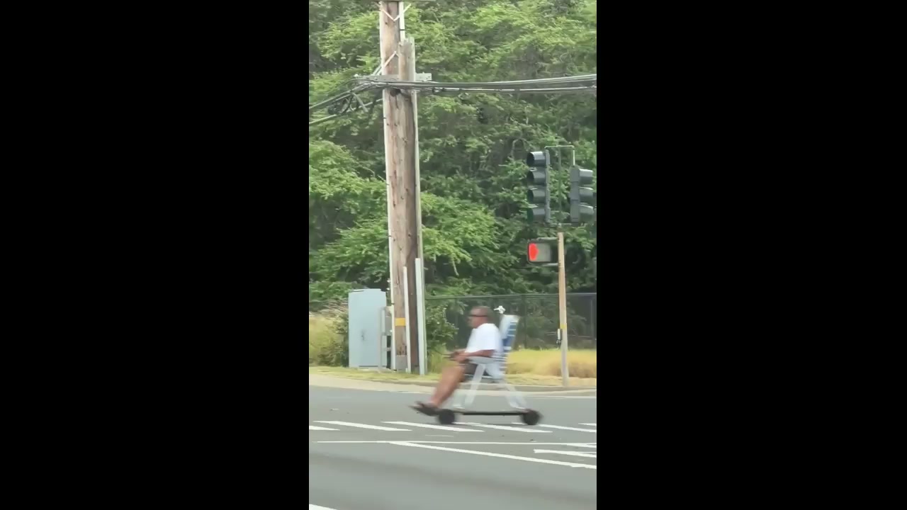 Man zips down road on motorized beach chair