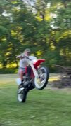 Woman loses control during dirt bike wheelie