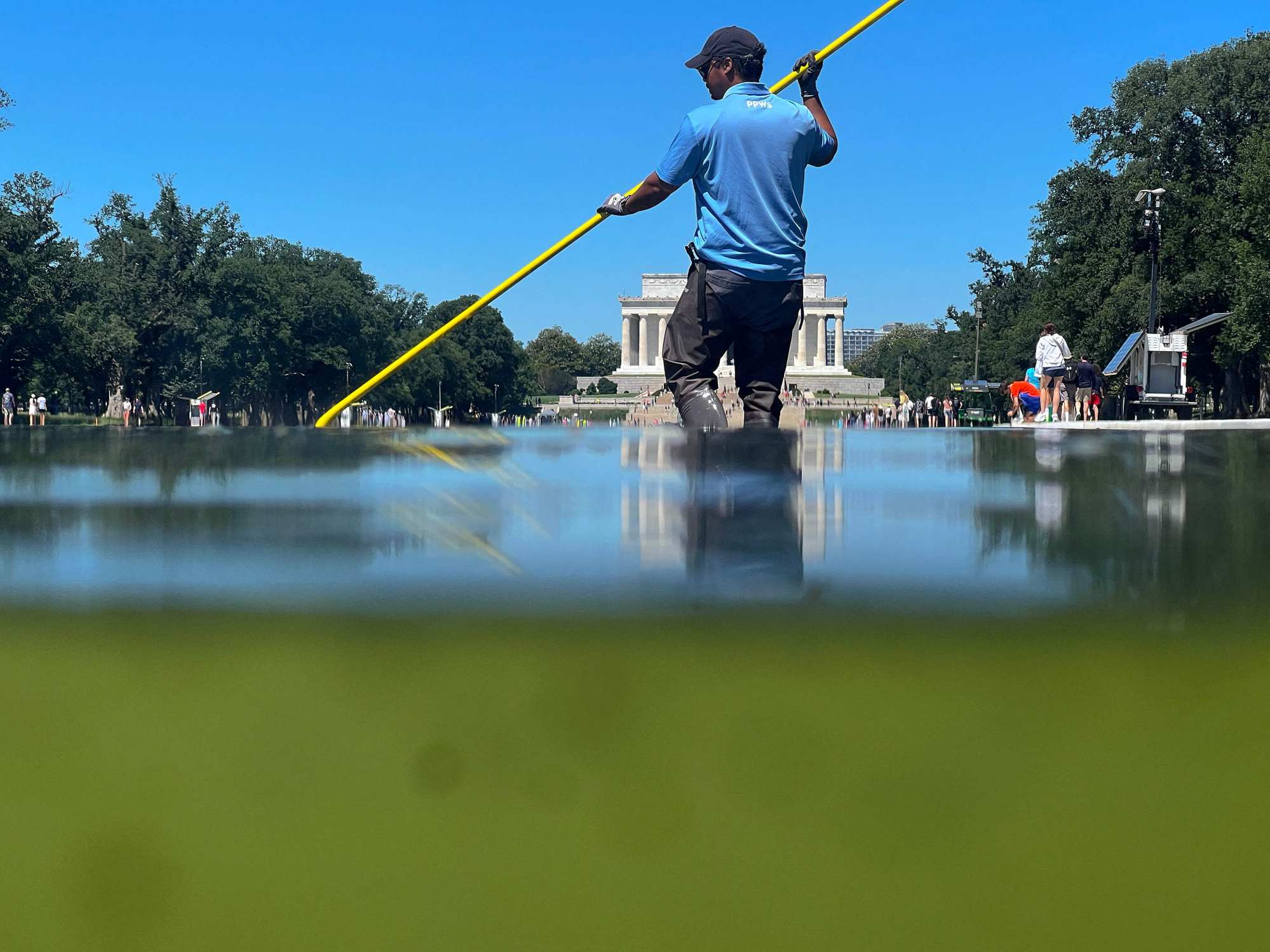 American flag blue? Algae turns Trump’s reflecting pool swamp green instead