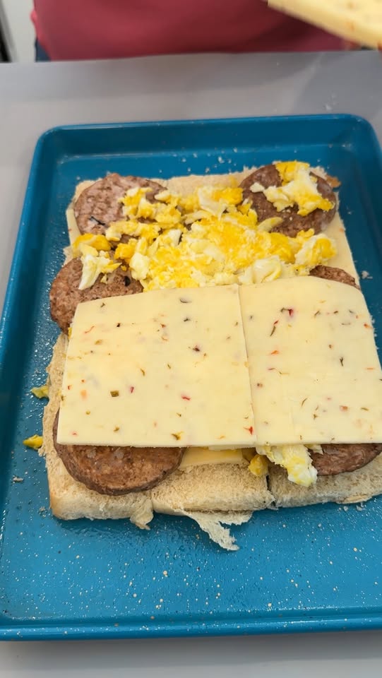 Breakfast sliders with sausage, eggs, and melted cheese