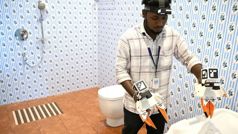 These workers are training AI robots to take their jobs