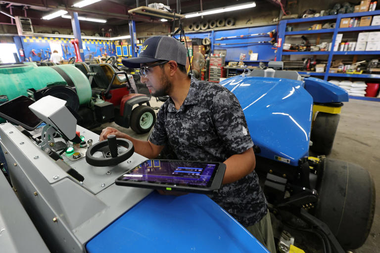 What's the deal with the robot mowers on many golf courses?