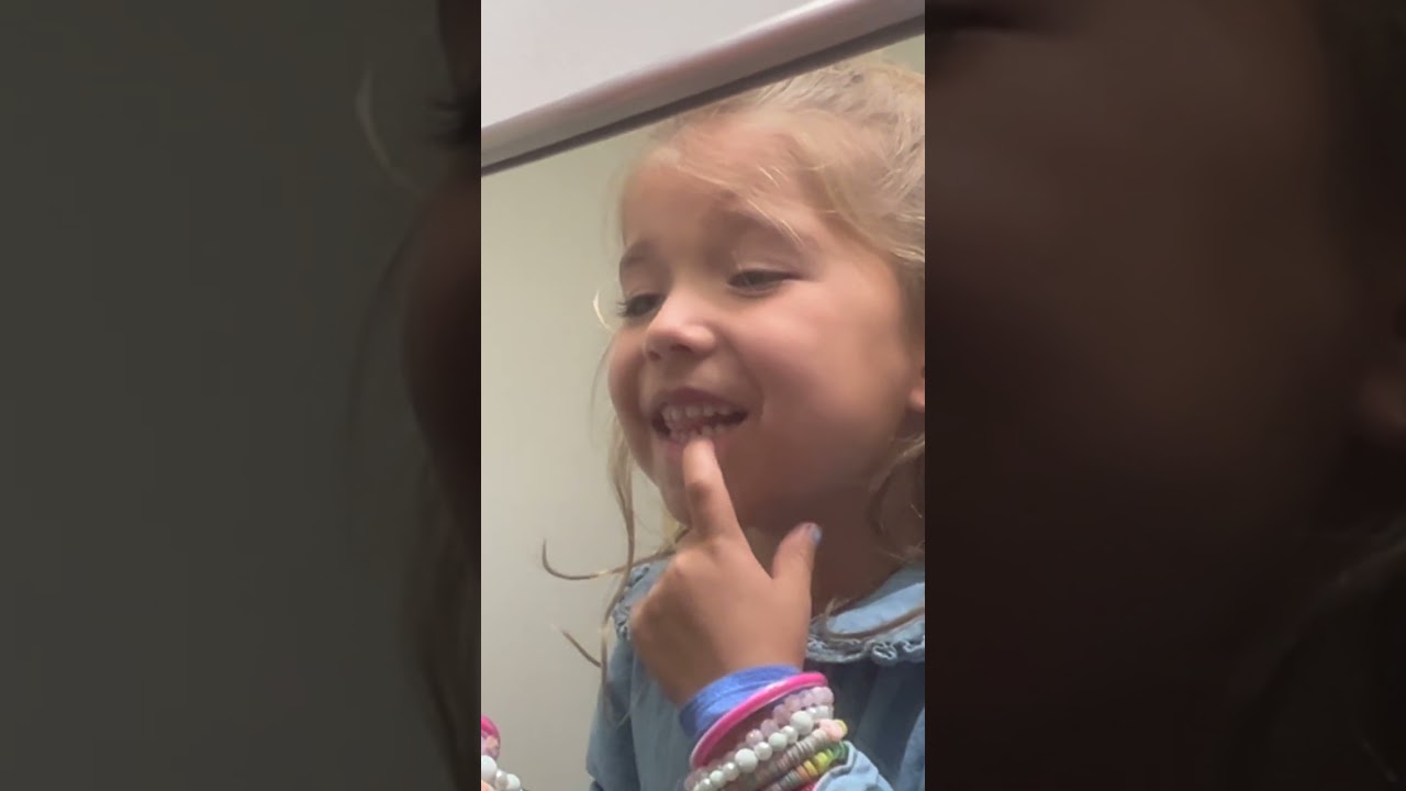 Young toddler successfully pulls out her very first loose tooth