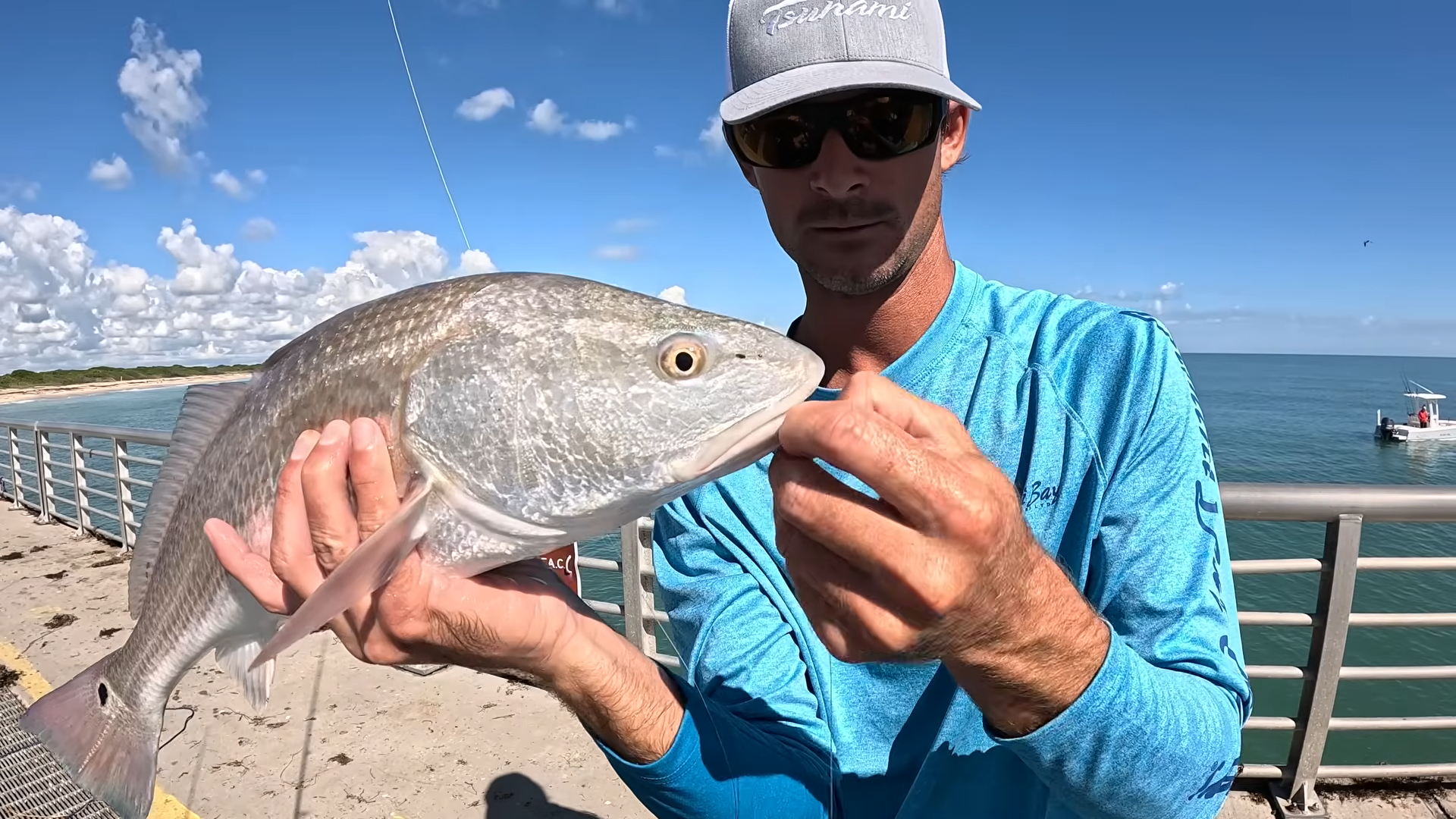 He grabbed the fish - then noticed the creepy mark watching back