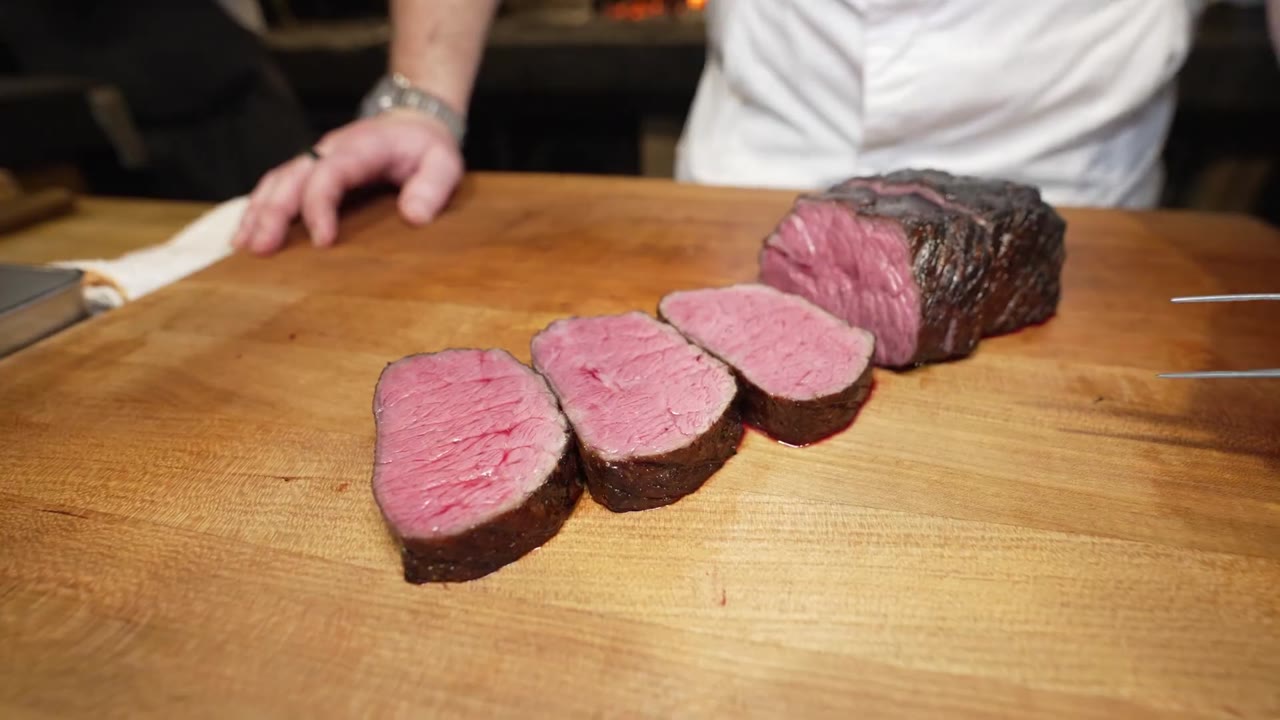 What happens when chefs cook steak on hot coals?