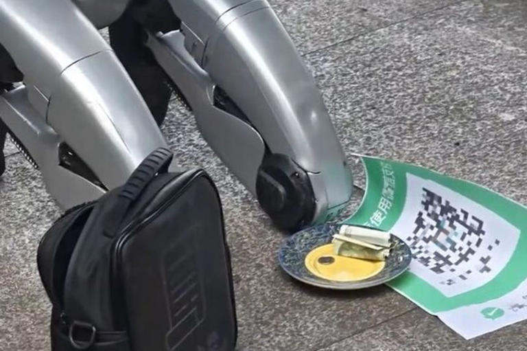 Robot spotted begging for cash on its knees in street after hitting ...