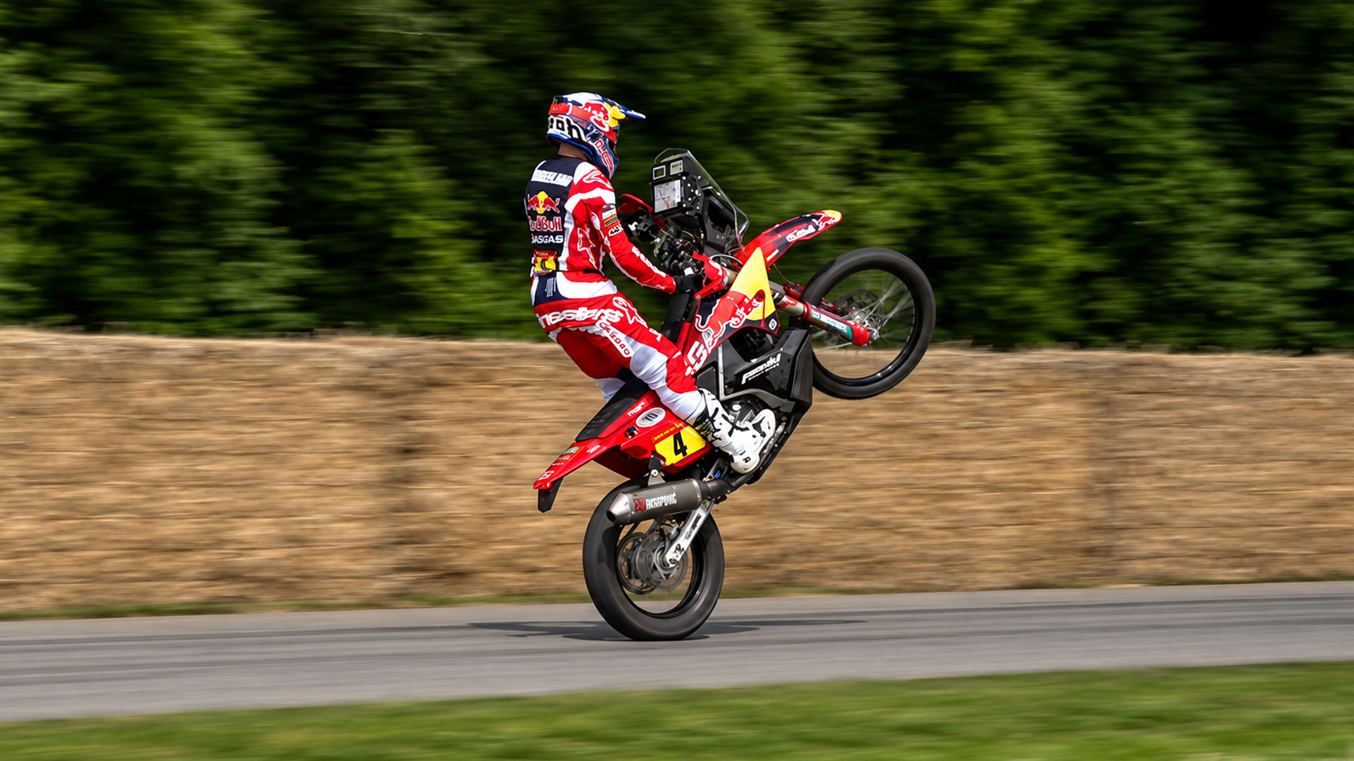 Rally rider pulled a wheelie at full speed on race track