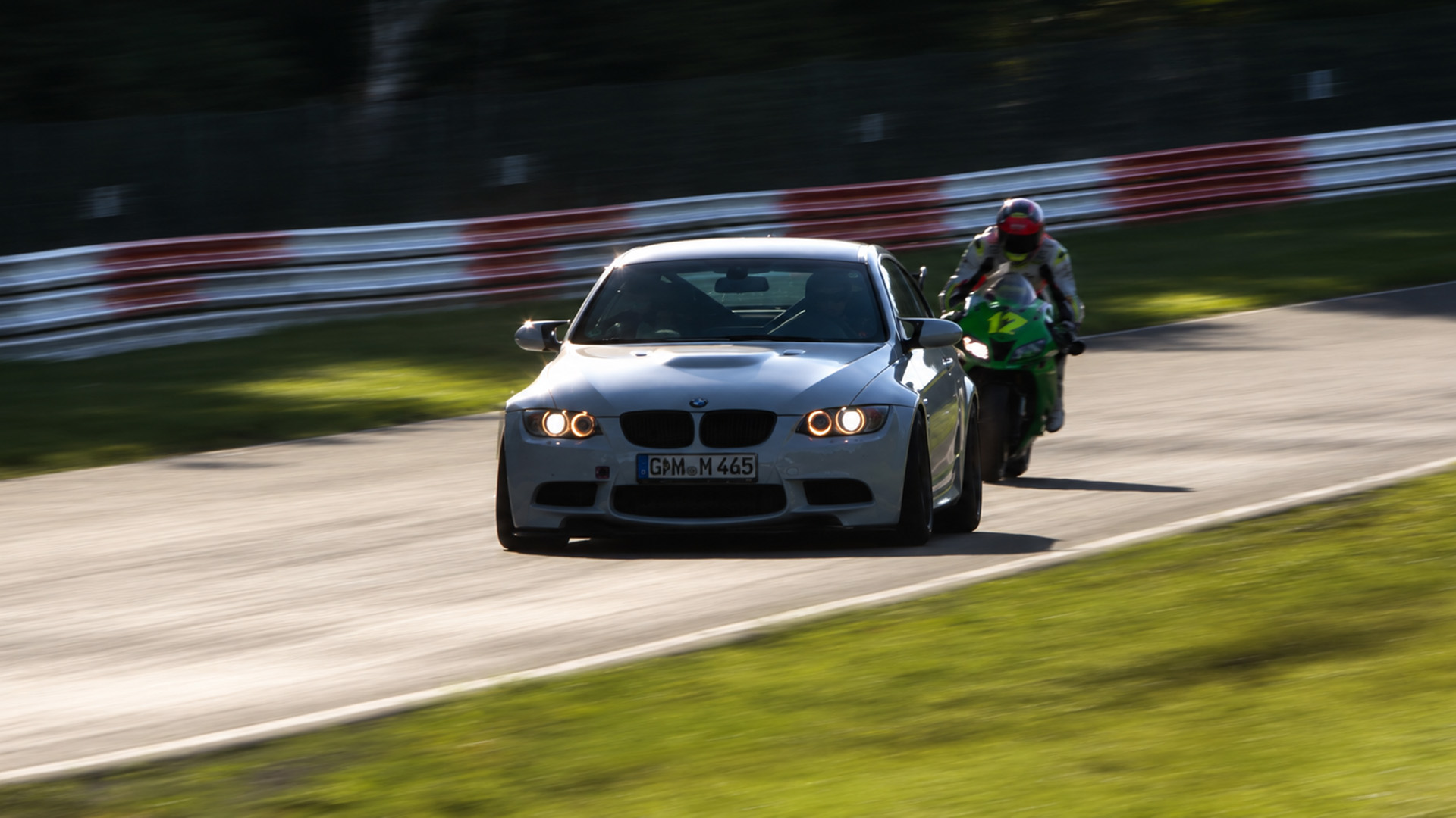 Motorcycle rider hunts down a BMW M3 on track