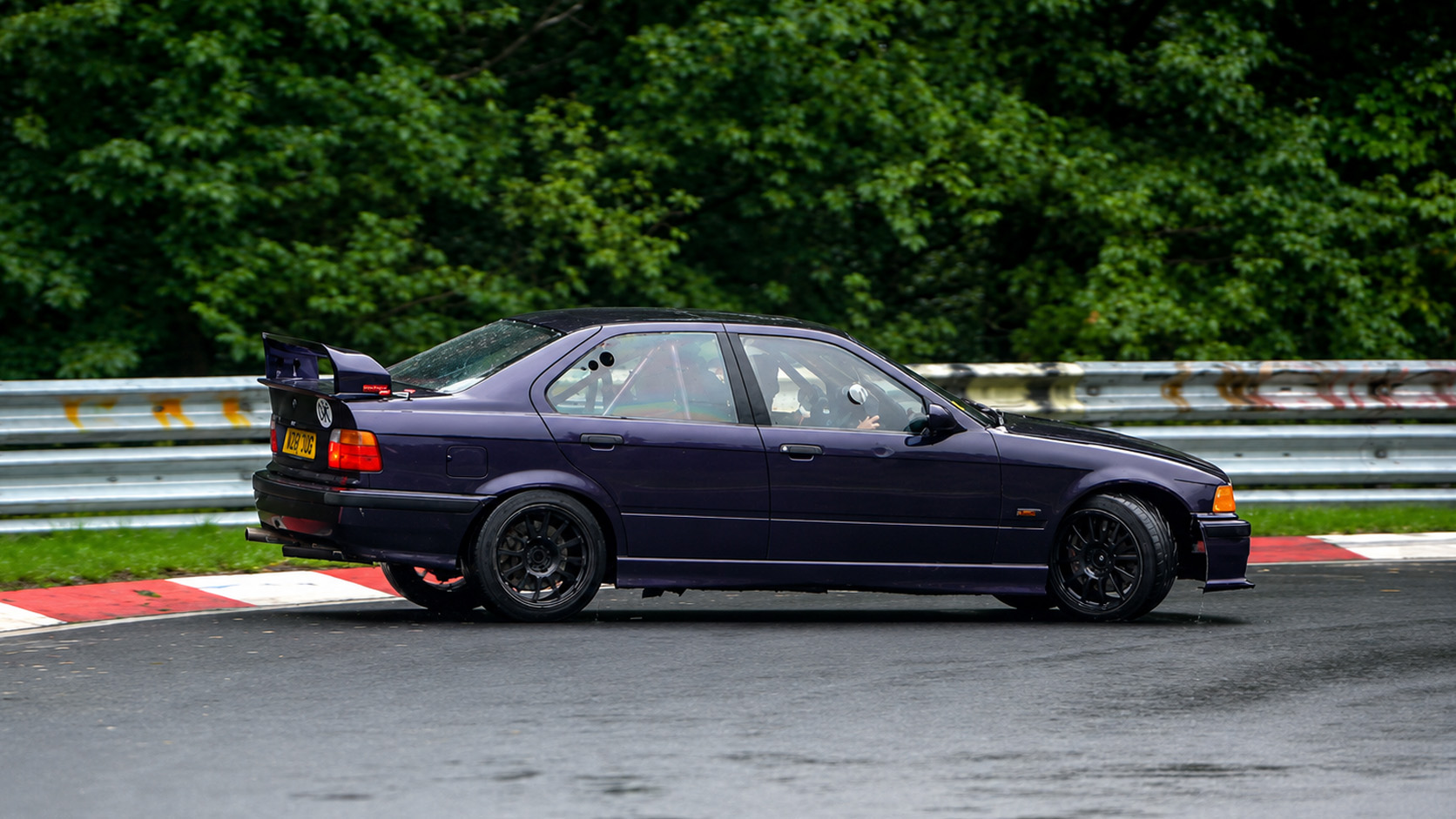 BMW loses grip and spins violently through a high-speed corner