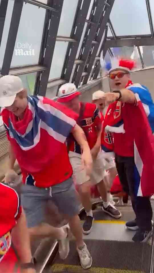 Norway fans perform 'Viking row' on escalator